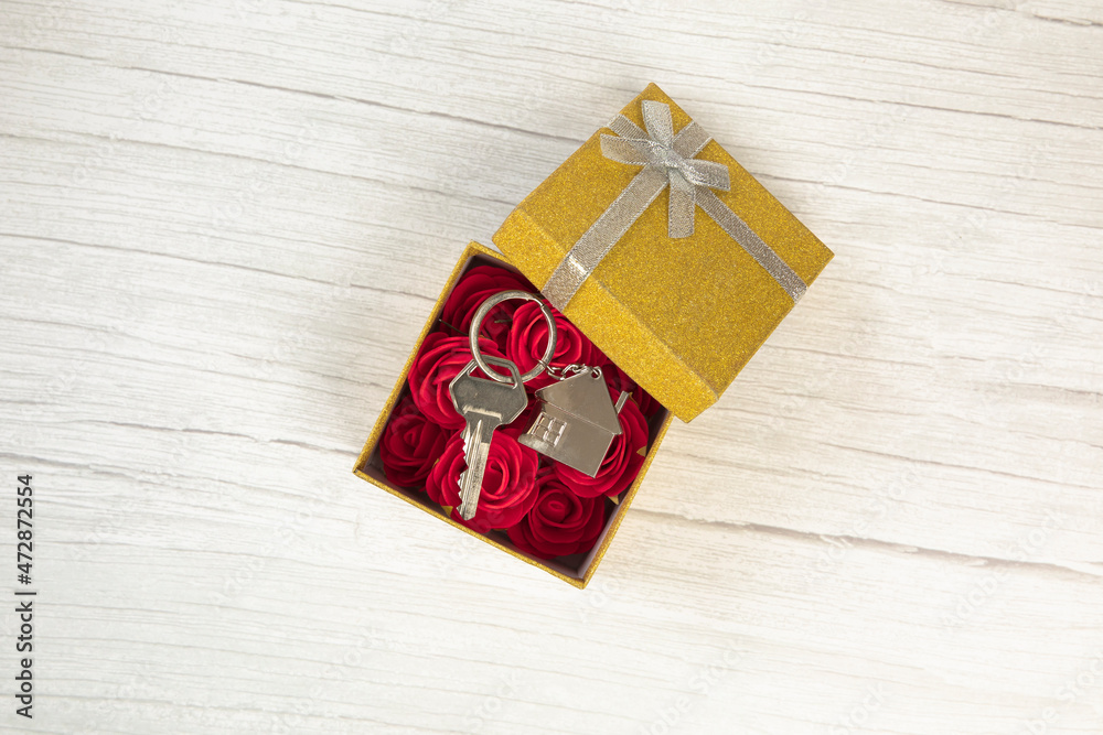 Silver new keys in golden sparkling gift box for buying new house ...