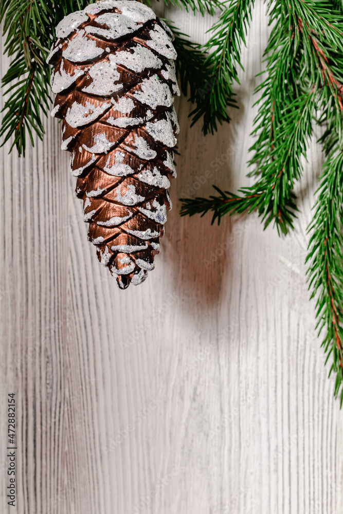 Spruce branch with bronze cones on a bleached wood texture background ...