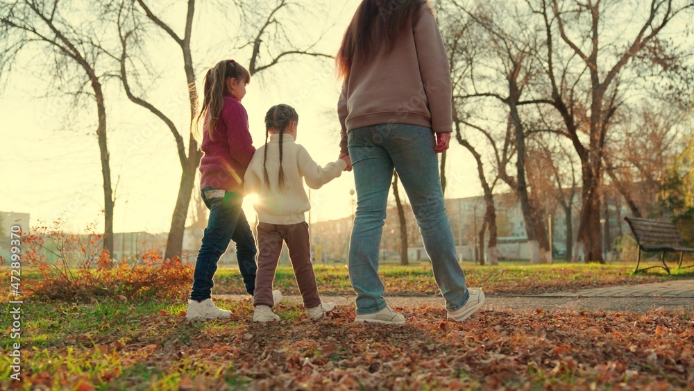 Happy family walk in the park in autumn. Mothers and children ...
