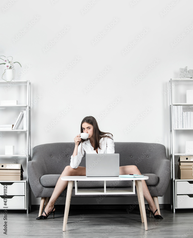 Seductive Secretary With Sexy Legs Drinking Coffee Sit On Sofa In