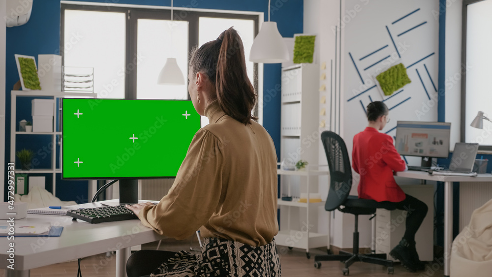 Employee working with green screen on computer in business office ...
