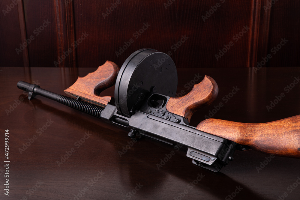Thompson submachine gun on a dark table vintage style background ...