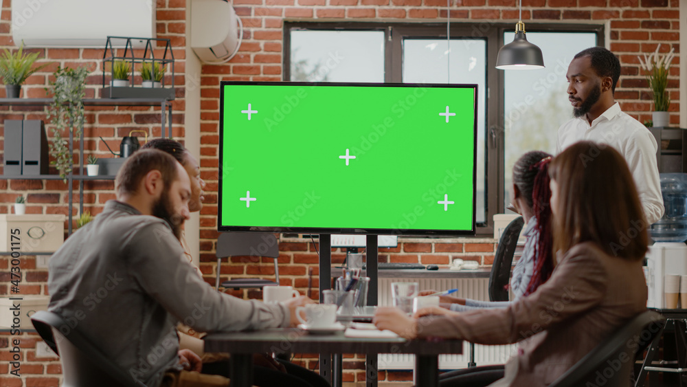 Business man presenting monitor with green screen at meeting with ...