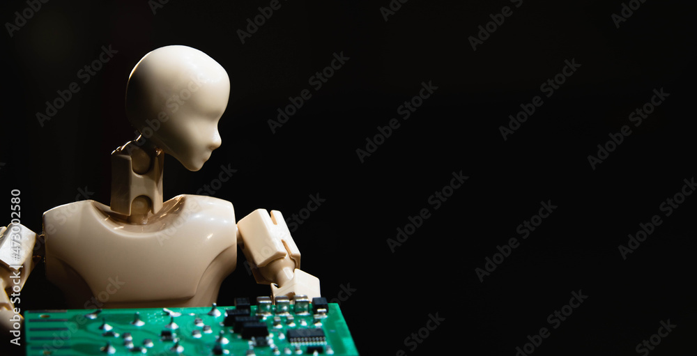 Humanoid robot with computer chip on a black background. Artificial ...