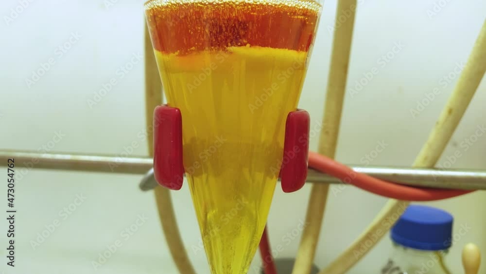 Separation of organic layer and water layer in separating funnel in a ...