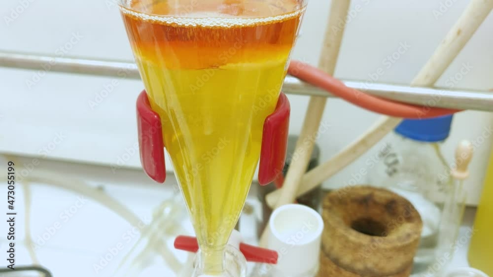 Separation of organic layer and water layer in separating funnel in a ...