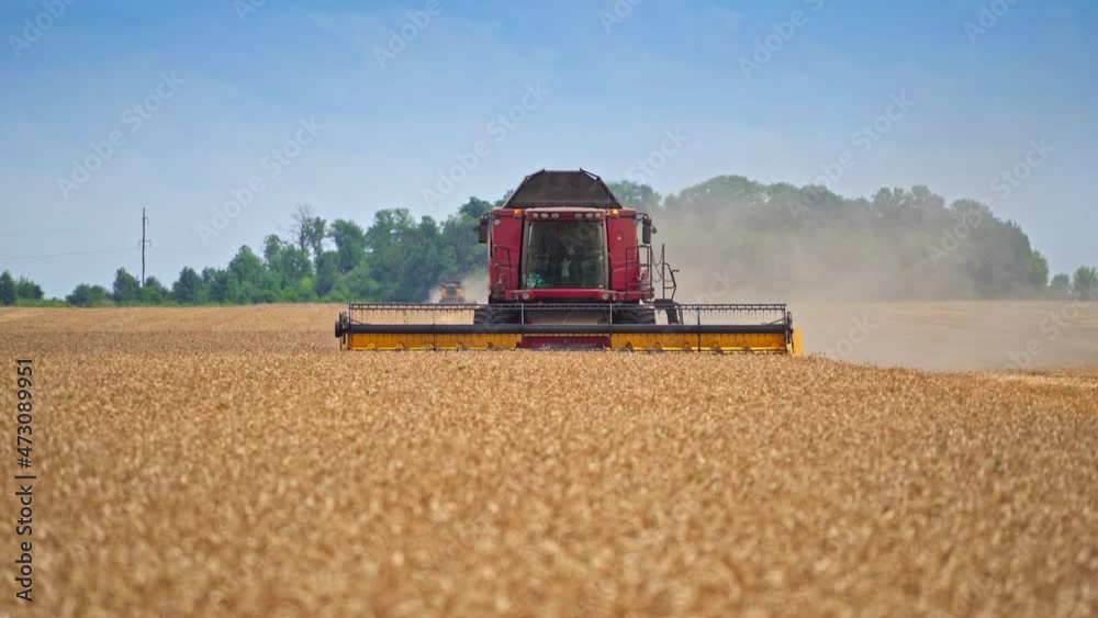 Modern agricultural machinery moving slowly by the beautiful yellow ...