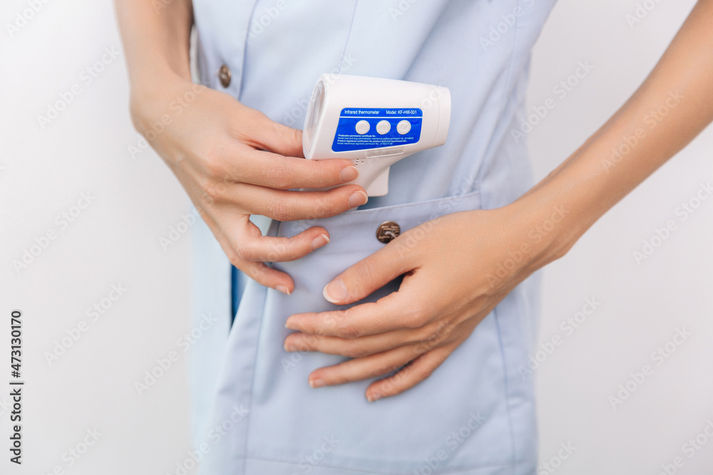 Temperature measurement gun in doctor hands. Close-up shot of doctor ...