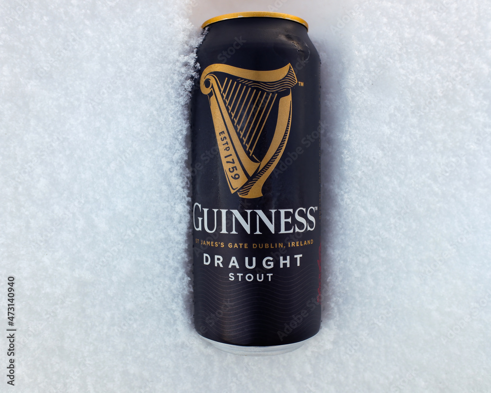 Can of Guinness draught Irish beer in snow, winter. Guinness is a ...