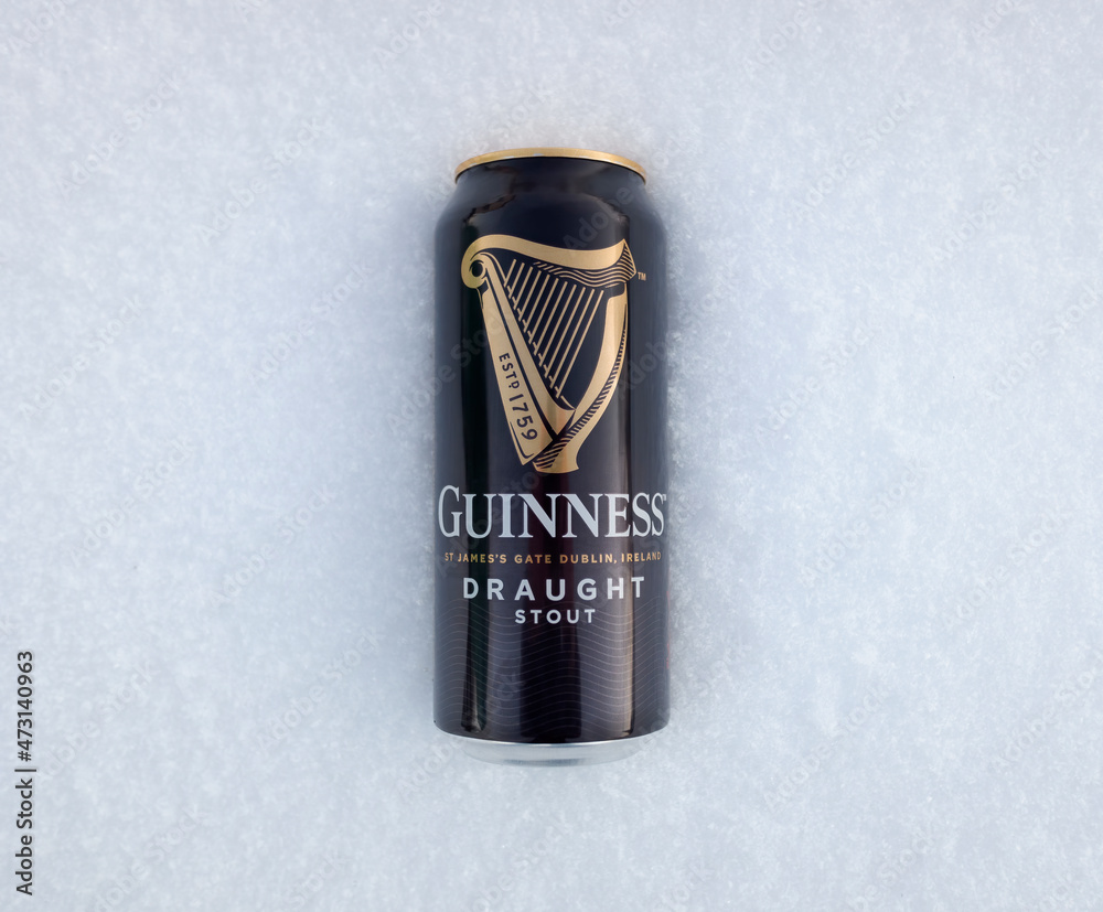 Can of Guinness draught Irish beer in snow, winter. Guinness is a ...