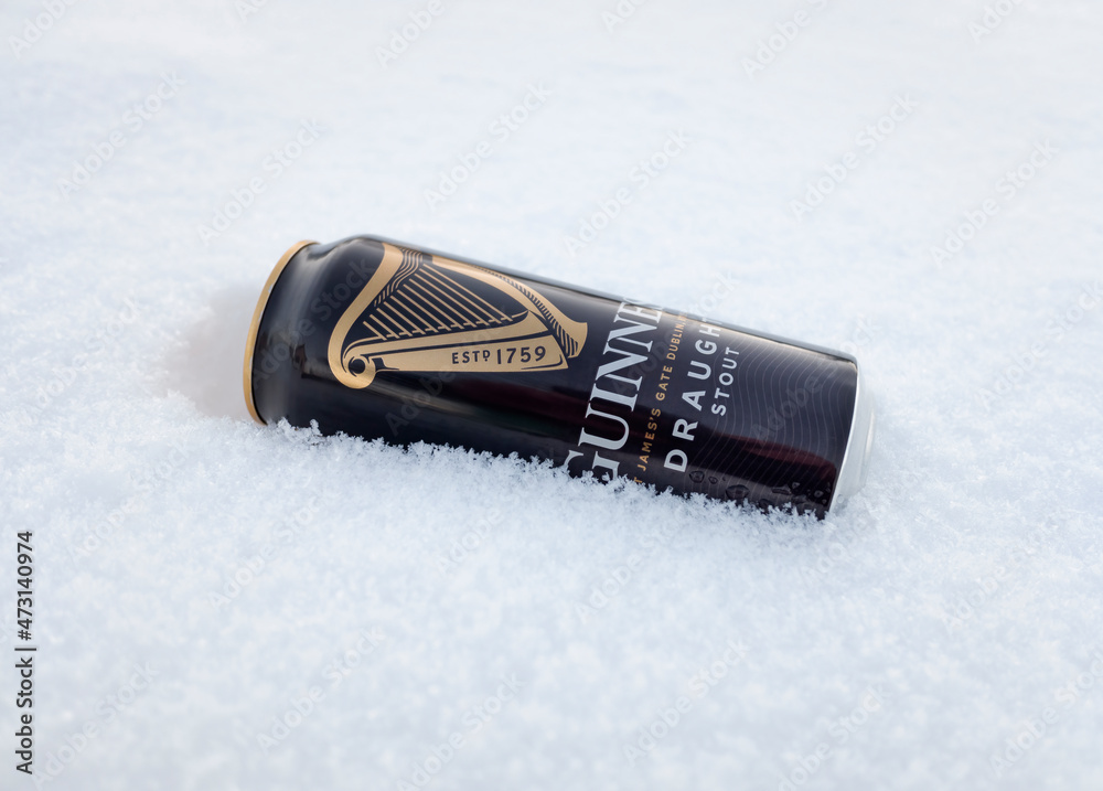 Can of Guinness draught Irish beer in snow, winter. Guinness is a ...