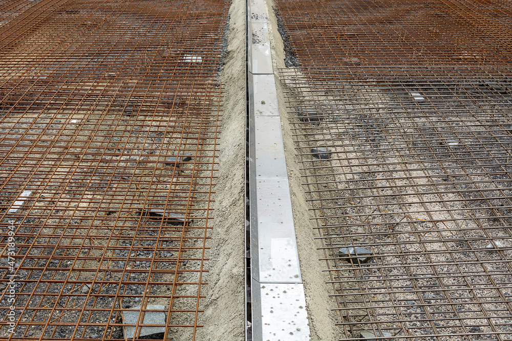 stormwater drainage channel and placing the reinforcing mesh around ...