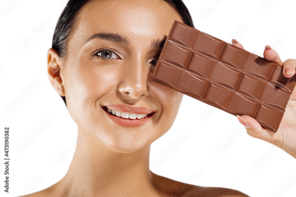 beautiful woman with makeup holding a chocolate bar on her face ...
