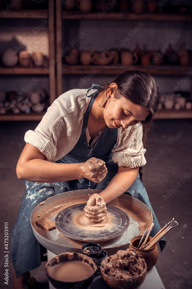 Beautiful handicraftsman master making pottery, sculptor from wet clay ...