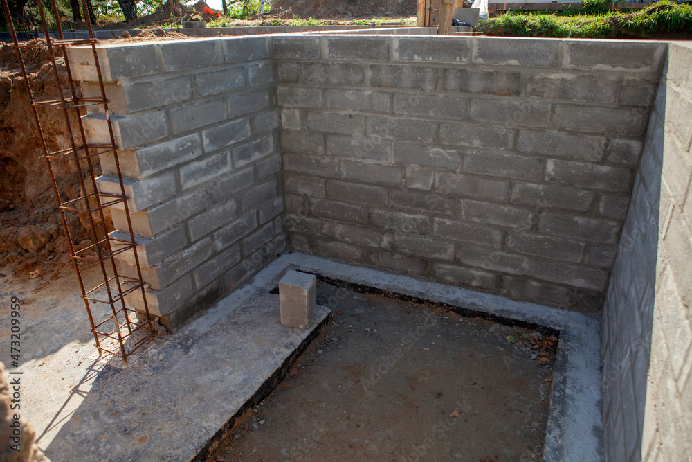 Brick foundation wall made of blocks and cement. Construction of a ...