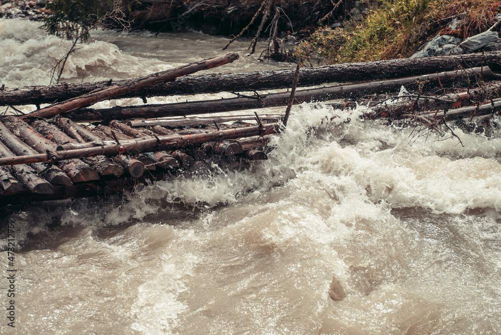 Fast turbulent river with broken bridge in water. Scenic mountain ...