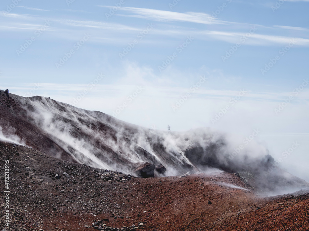 Silhouette of man hiking at coldera of Avachinsky stratovolcano, also ...