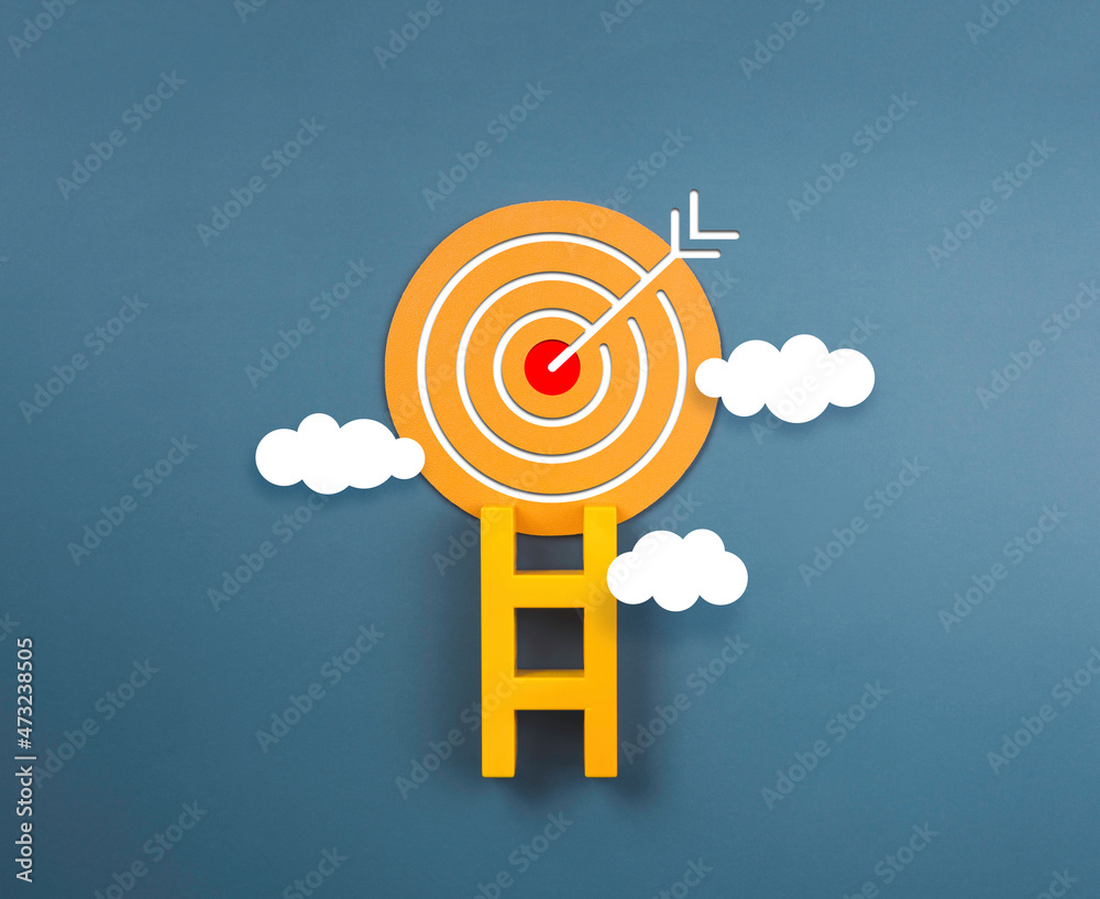 The big goal target icon symbol is on a yellow ladder and white clouds ...