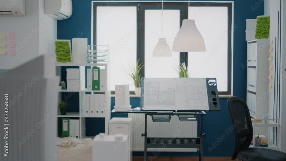 Nobody in office with blueprints plans to design building model for ...