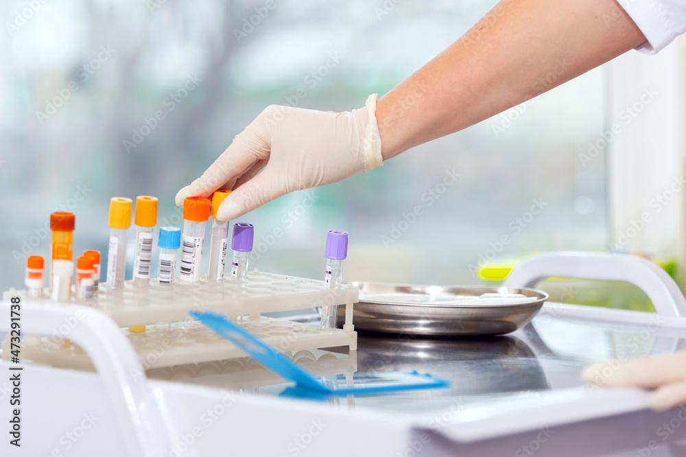 Test tube in scientist hand in laboratory. Doctor in uniform working ...