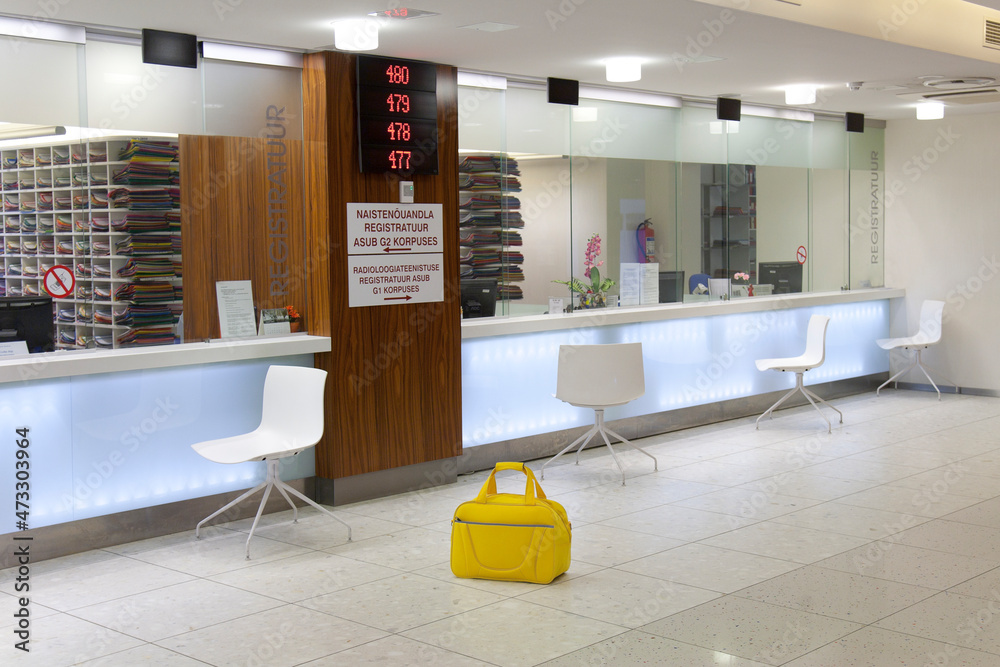 Waiting area and reception desk at a modern hospital, with signs and ...