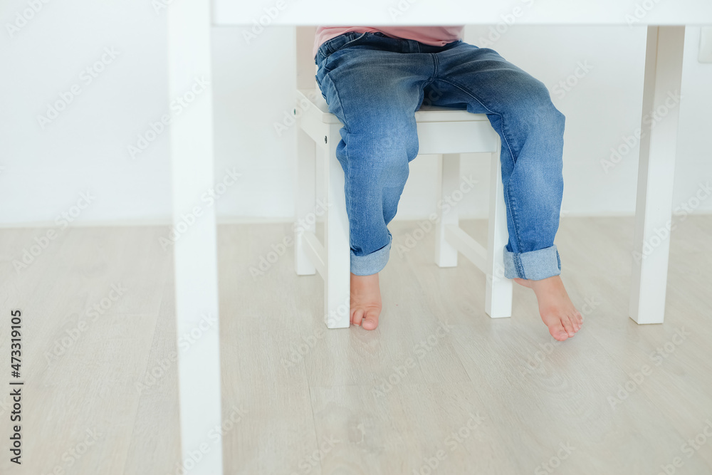 child's legs of child girl view under the table Stock-Foto | Adobe Stock