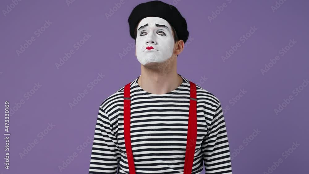 Excited proactive young mime man with white face mask wears striped ...