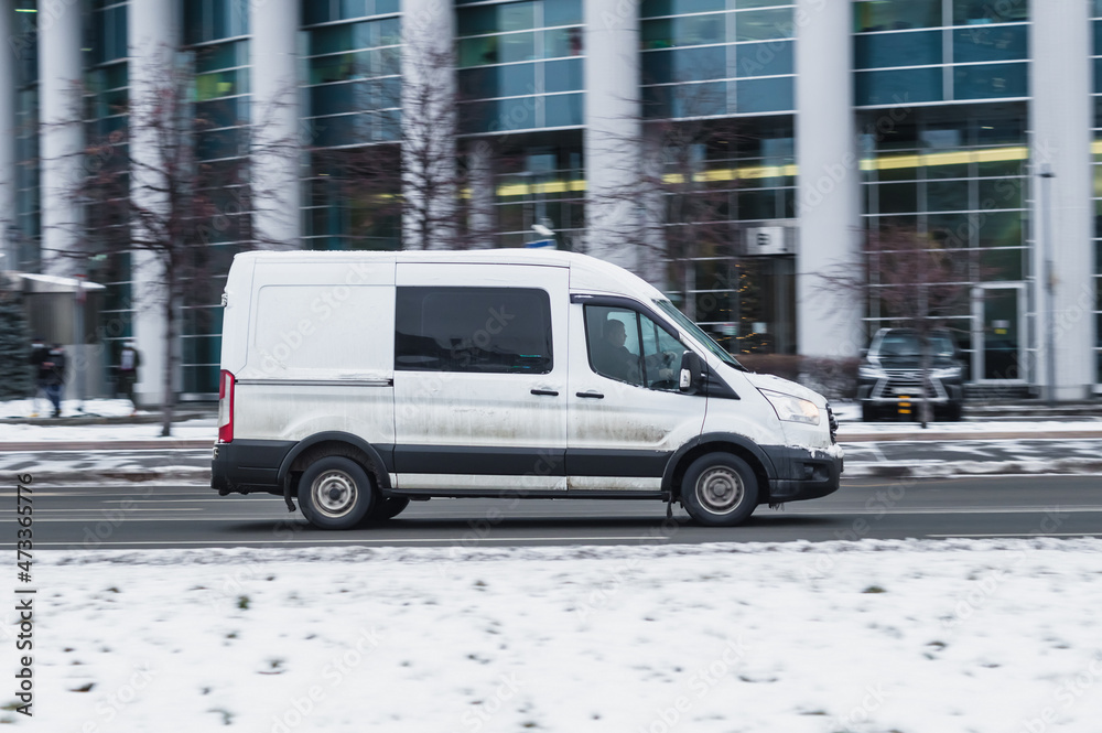 Ford Transit Fourth generation van in the city street at winter. Side ...