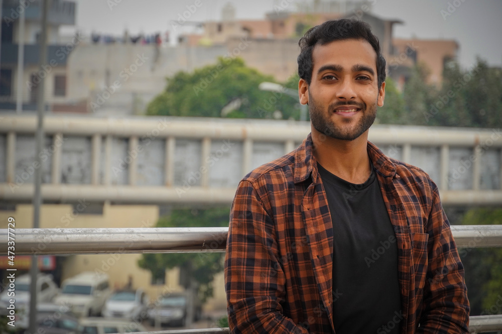 Indian man on bridge giving a smile and watching camera Stock Photo ...