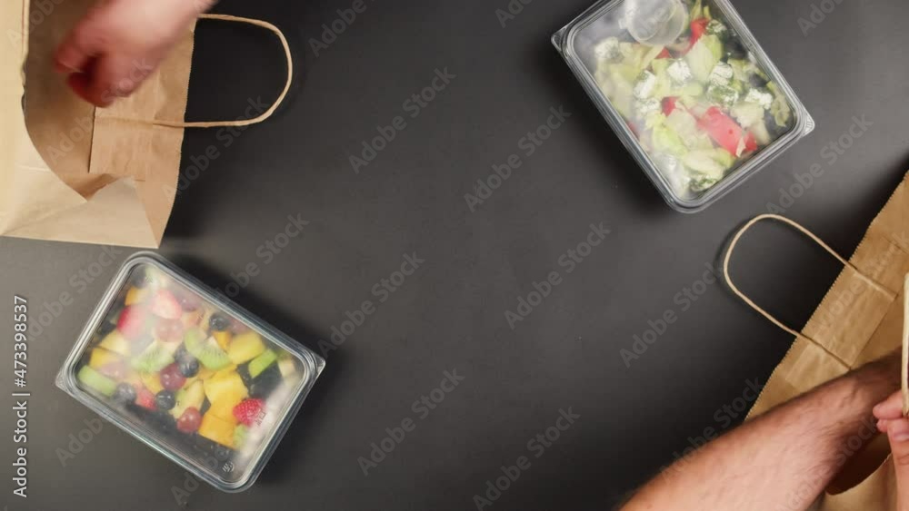 Packaging take away meals into paper bags top view, Food delivery in ...
