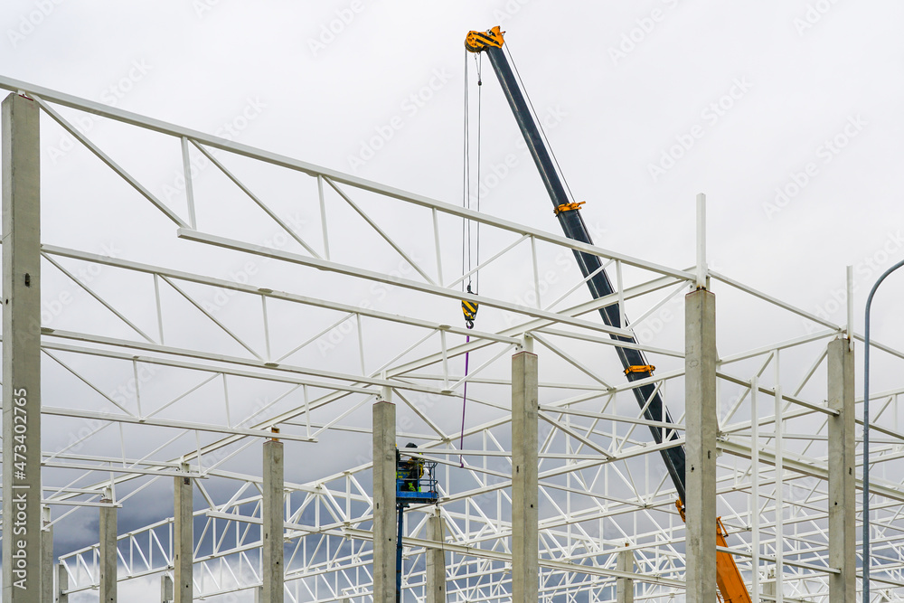 crane with telescopic boom in the assembly of metal structures of an ...
