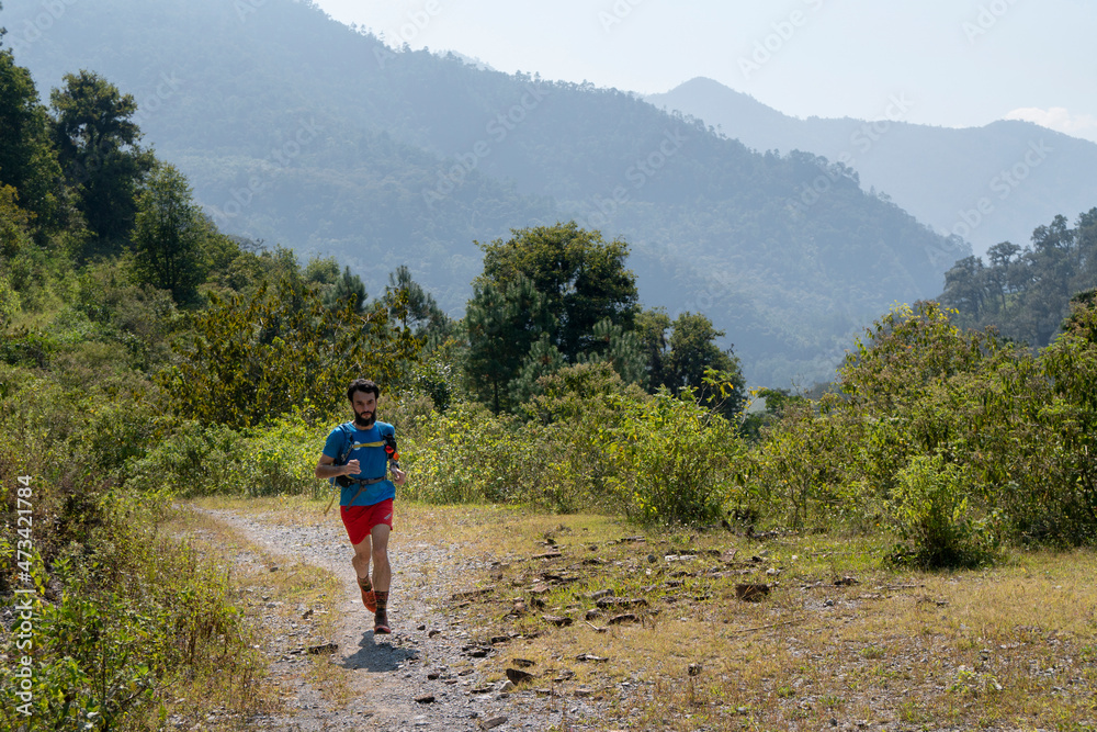 One man running on a trail at the bottom of a canyon Stock Photo ...