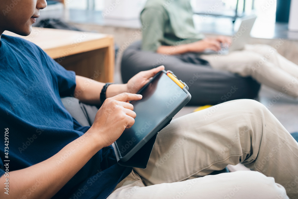 Young collage student using computer and mobile device studying Stock ...