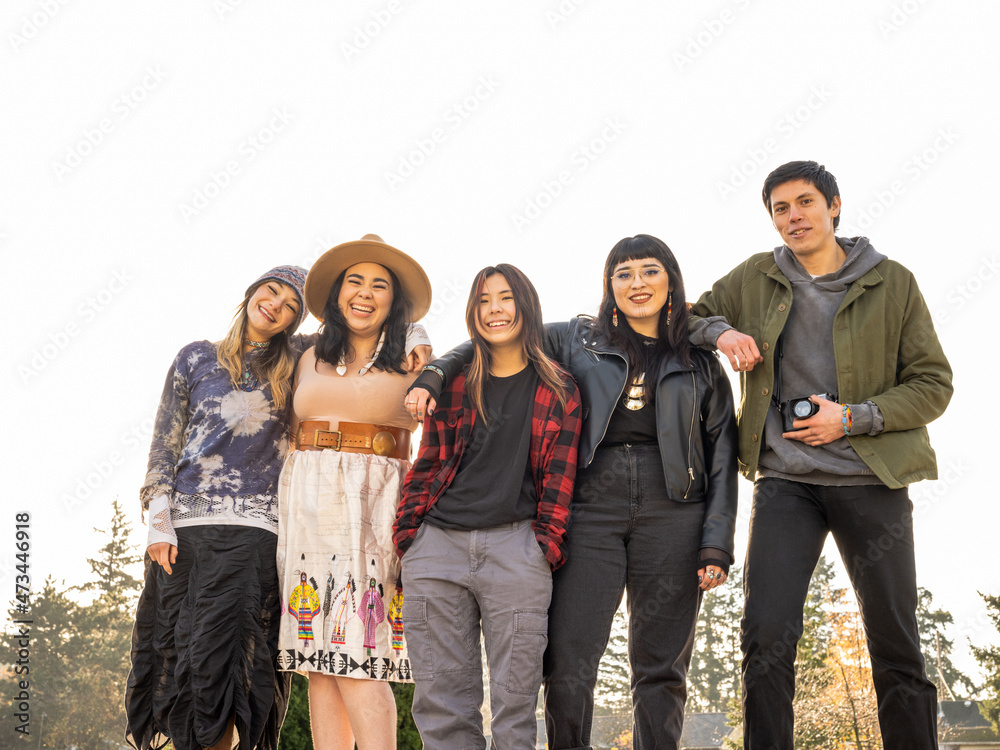 Young Indigenous friends hanging out outdoors Stock Photo | Adobe Stock