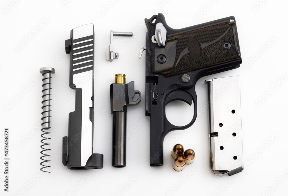 Parts of .380 semi automatic pistol handgun with bullets on white ... Parts of .380 semi automatic pistol handgun with bullets on white ...