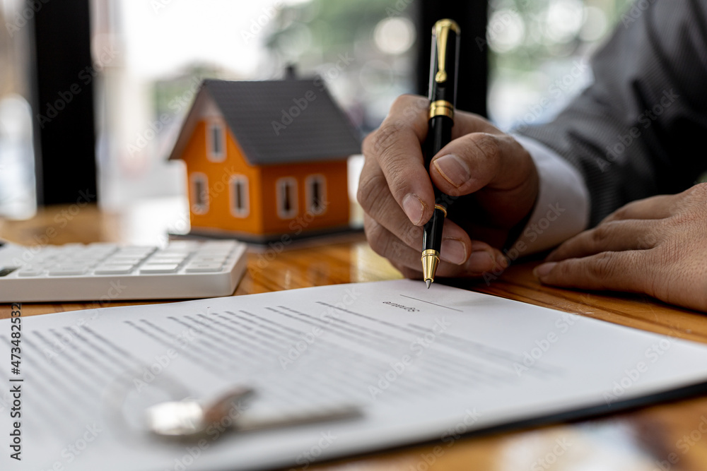 Man checking documents on table, housing salesman checking for ...