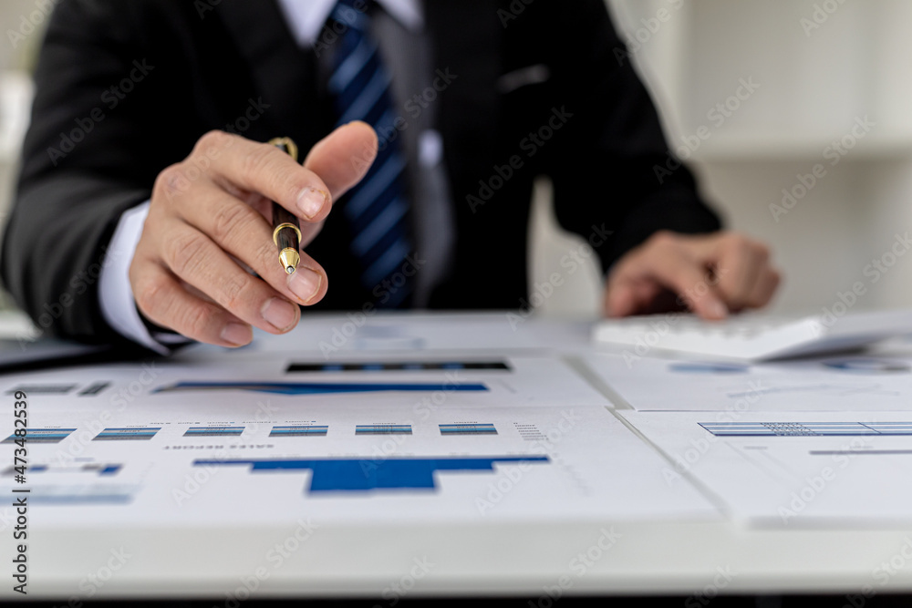 Business finance person is reviewing a company's financial documents ...