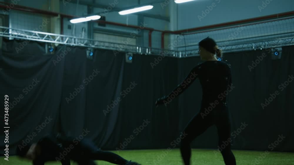 Male and female actors wearing motion capture suits performing some ...