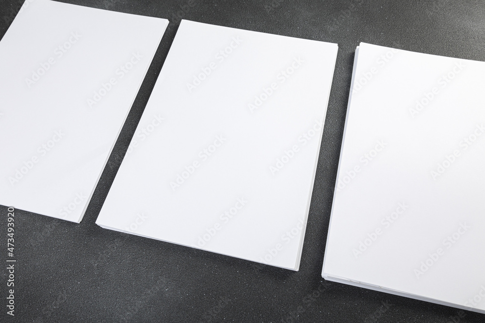 Blank flyer poster A4 paper isolated on dark gray to replace your ...
