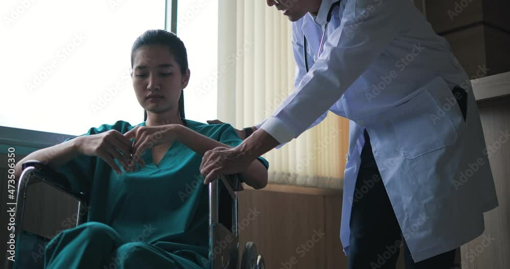 In the hospital, a friendly Asian doctor spoke with a wheelchair-bound ...
