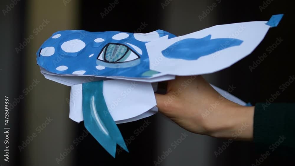 Blue origami dragon with long tongue in child hands, paper dragons ... Blue origami dragon with long tongue in child hands, paper dragons ...
