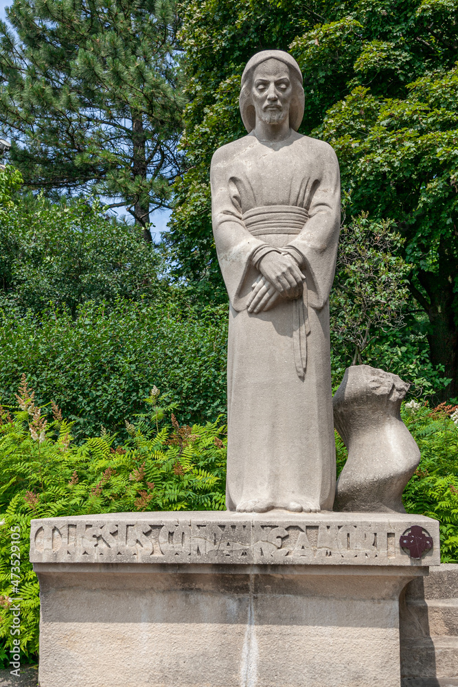 Statue of Jesus with hands folded and contemplative eyes in the garden ...
