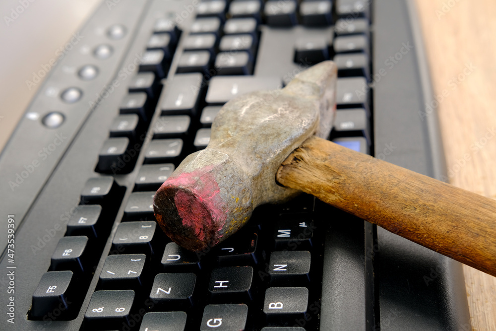 closeup computer keyboard, iron hammer hits keys with force, breaks ...