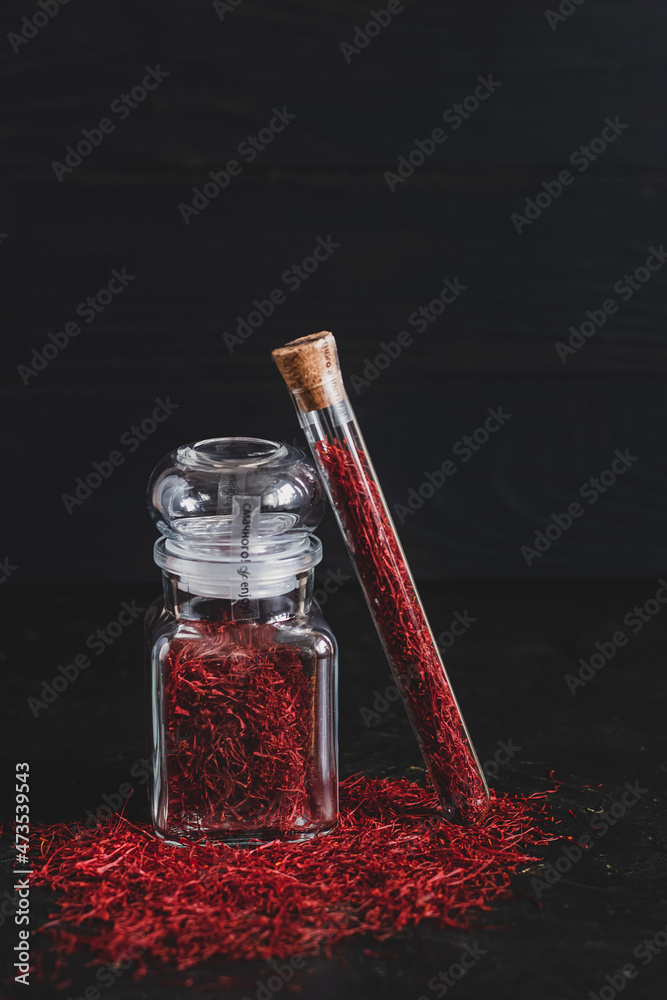 Raw organic red dried saffron spice on wooden background in vintage ...