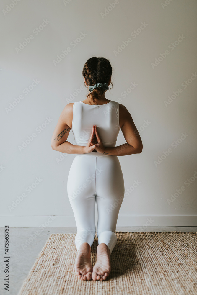 Flexible yogi practicing hands behind back yoga posture at health club ...