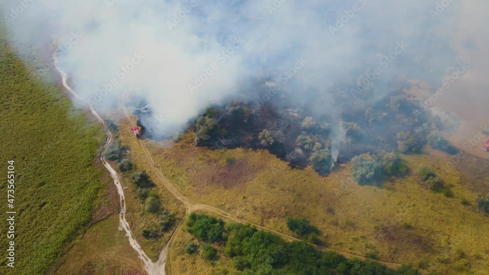 Fire engine near area is engulfed in conflagration and smoke due to ...
