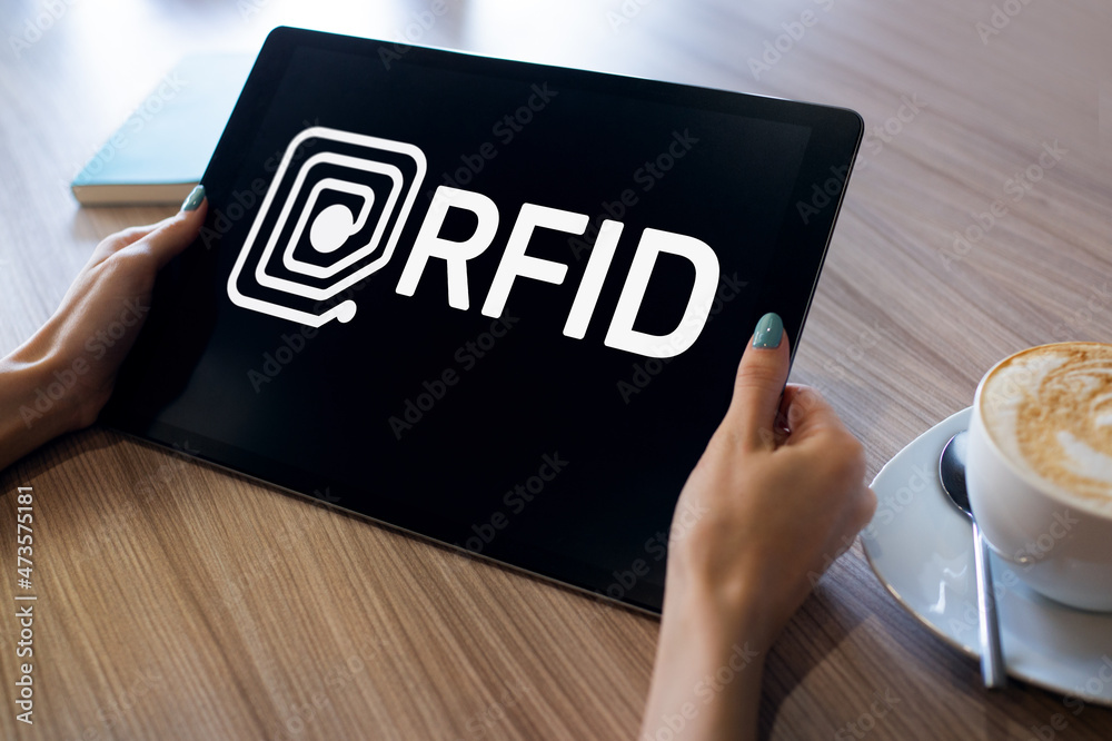 RFID Radio frequency identification technology concept on device screen ...