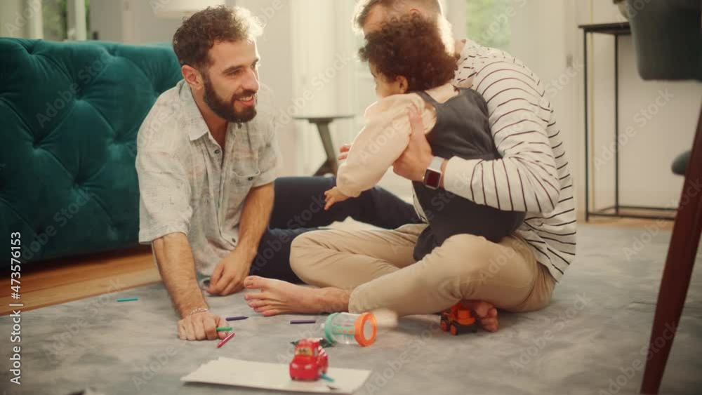 Loving LGBTQ Family Playing with Toys with Adorable Baby Boy at Home on ...