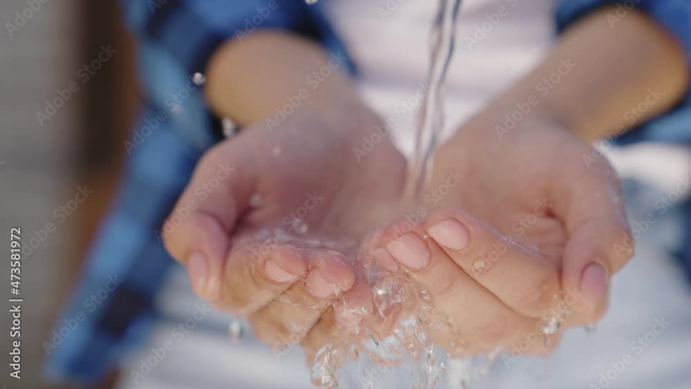 clean water flows into the hands of a working person, keep clean when ...