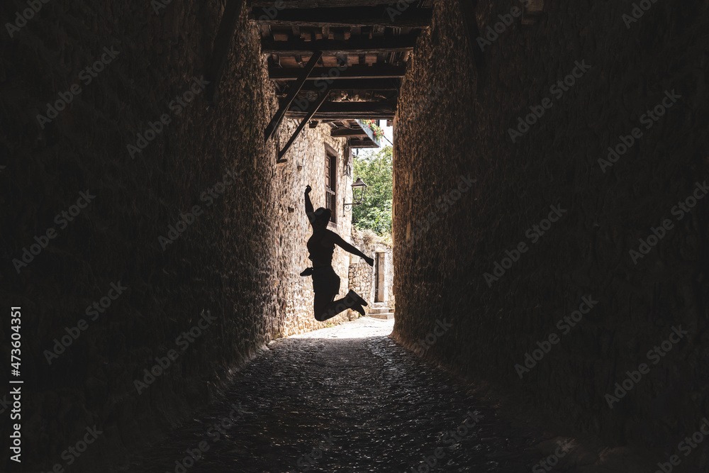 Horizontal view of woman outline with arms up in the air jumping. Front ...